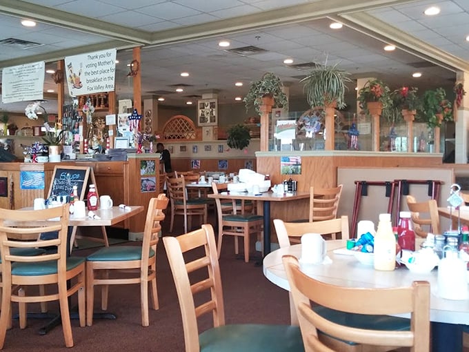 Wooden chairs, teal cushions, and hanging plants create that perfect "grandma's dining room" vibe where calories don't count and seconds are practically mandatory.