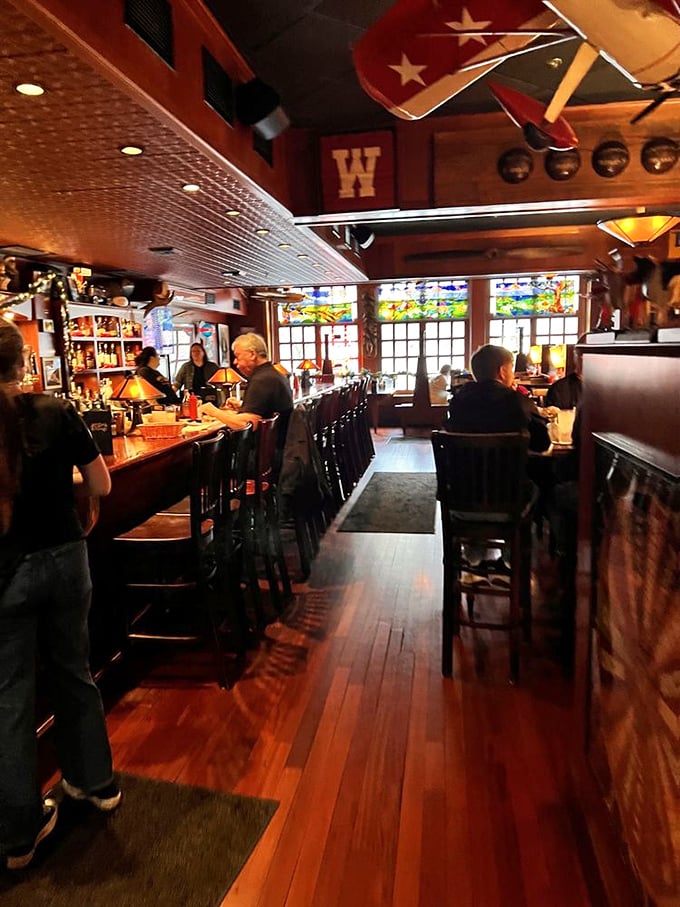Warm wood, stained glass, and that unmistakable Wisconsin "W" – this isn't just a restaurant, it's a shrine to comfort food.