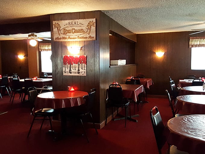 Wood paneling, red tablecloths, and that warm amber glow – this isn't trendy design, it's the authentic stage where comfort food becomes performance art.