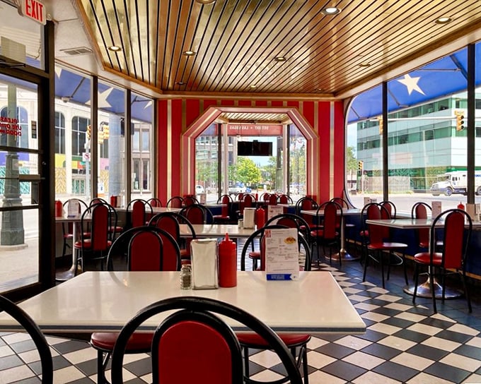 Step inside and time stands still—red vinyl booths, checkerboard floors, and wooden ceilings create the perfect backdrop for Detroit's most famous food feud.