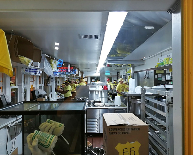 Behind the scenes, the yellow-shirted custard commandos work their magic in a kitchen choreography perfected over decades. Dessert alchemy in action.