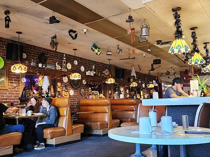 Tiffany lamps dangle from a ceiling festooned with curiosities while caramel-colored booths cradle generations of Portlanders. This isn't décor—it's a living museum of comfort.