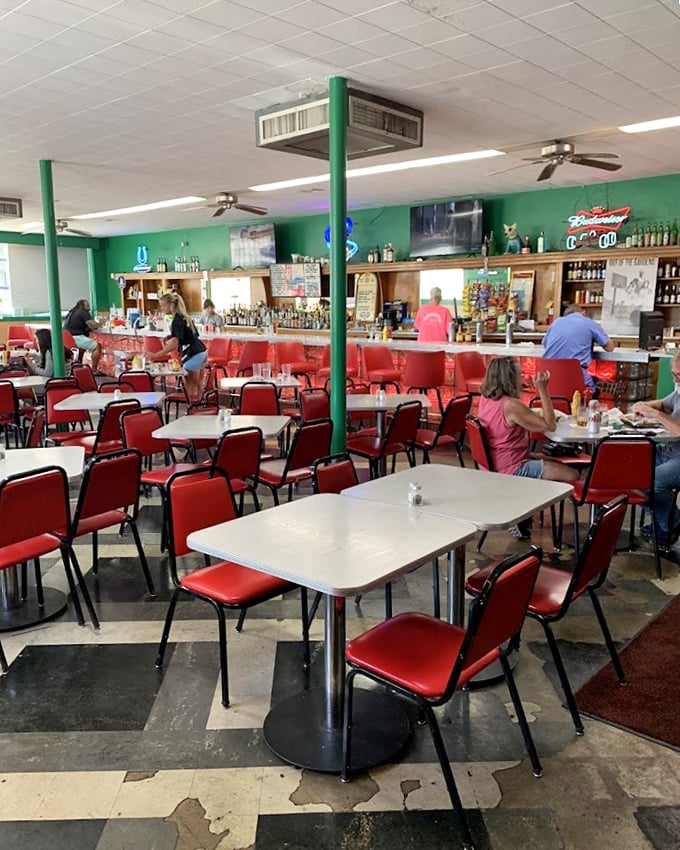 The dining room's red vinyl chairs and green walls aren't trying to be retro—they're authentic survivors from an era when function trumped Instagram aesthetics.