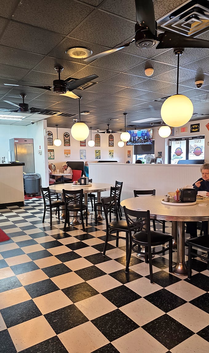 Classic black and white checkered floors meet cozy globe lighting—this isn't just a restaurant, it's a time machine to simpler, more delicious days.