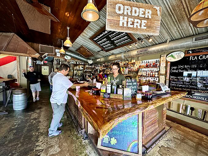 Where rustic meets refreshment – this bar isn't just serving drinks, it's serving stories with every pour beneath that corrugated metal ceiling.