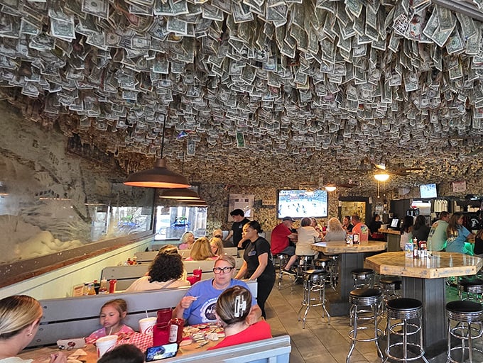 Money talks, but at Shuckums it also decorates. Thousands of dollar bills create a currency canopy that's part folk art, part retirement fund.