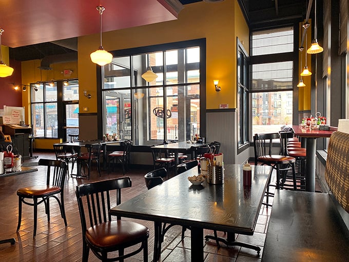 Warm yellow walls and pendant lighting create that perfect "everybody knows your name" vibe, minus Norm but with better breakfast options.