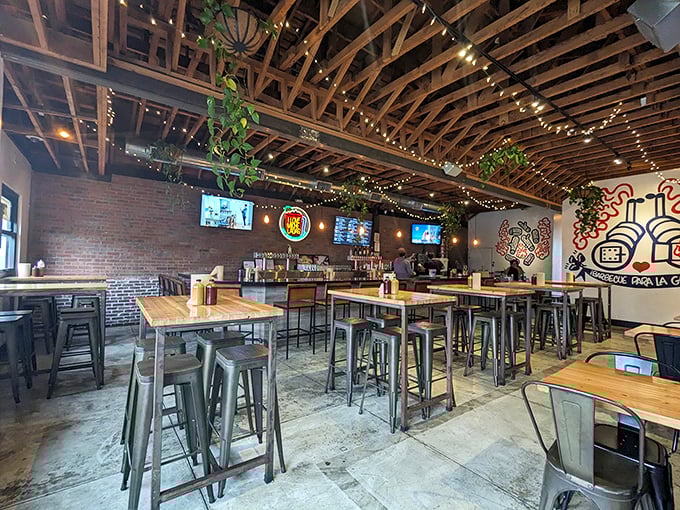 Edison bulbs and exposed beams create the perfect backdrop for meat meditation. The industrial-chic interior says "serious barbecue business happens here."