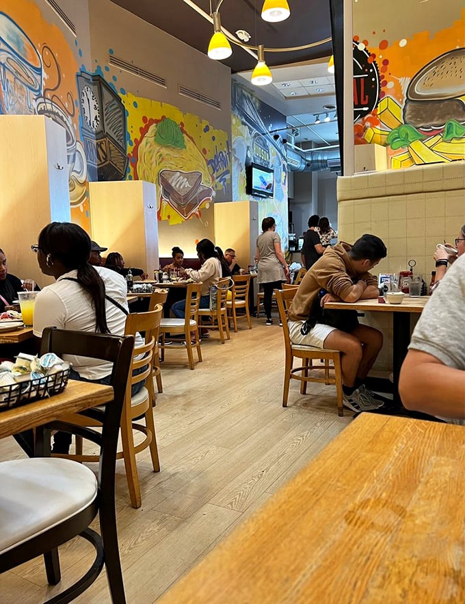 Vibrant food murals dance across the walls while diners enjoy their morning feast—proof that breakfast deserves its own art gallery.