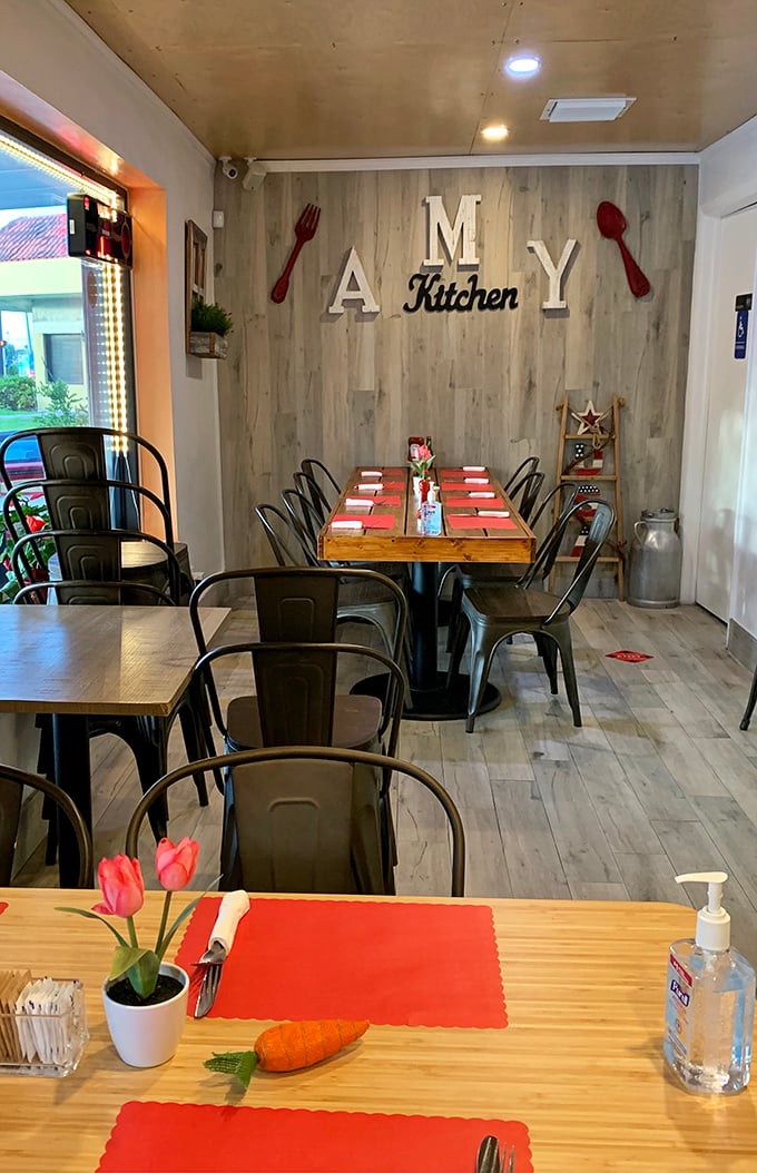 Inside, the "AMY Kitchen" wall with oversized red utensils sets the tone—serious about food, but never stuffy. Those fresh tulips are the perfect touch.