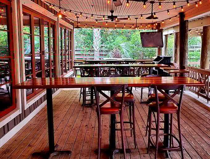 String lights, wooden beams, and ocean breezes—this patio seating area turns casual dining into a memory you'll revisit during winter.