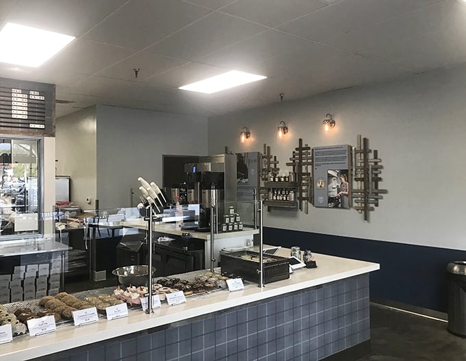 Clean lines, blue accents, and that unmistakable bakery aroma – this is what donut heaven's waiting room looks like.