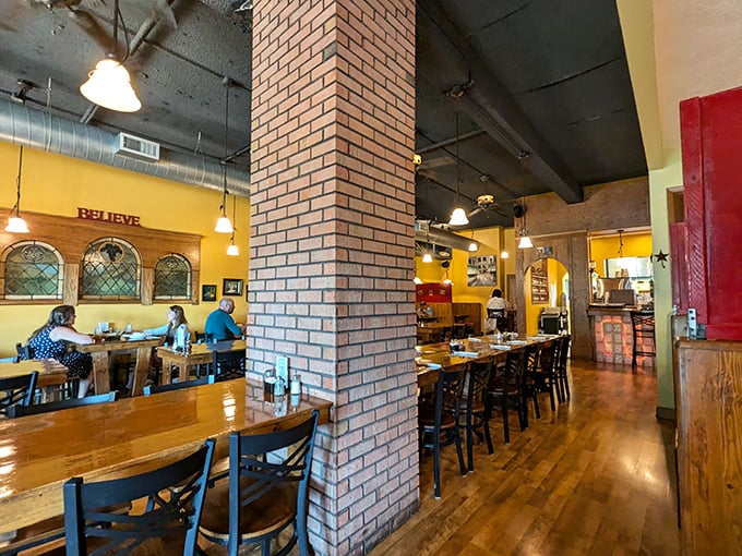 Warm yellow walls, exposed brick, and wooden tables create that "Nonna's dining room" feeling—comfortable, unpretentious, and ready for serious eating.