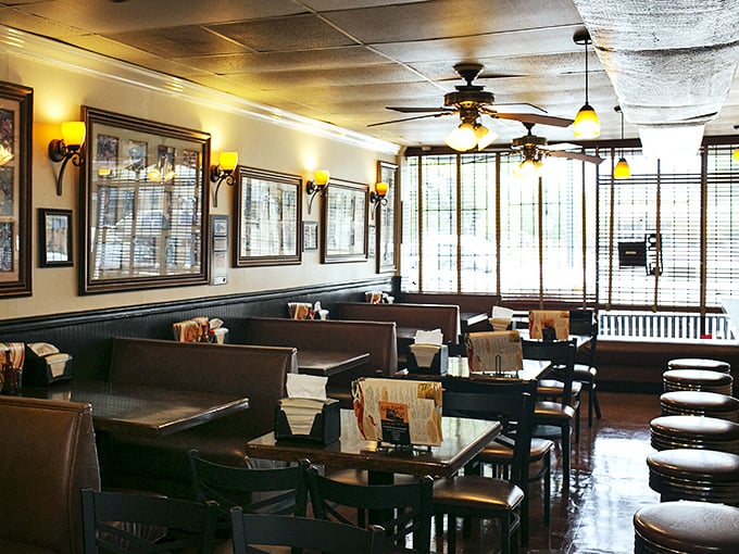 Warm lighting, wood paneling, and cozy booths create the perfect backdrop for soul food communion. This isn't just dining—it's a Southern living room.