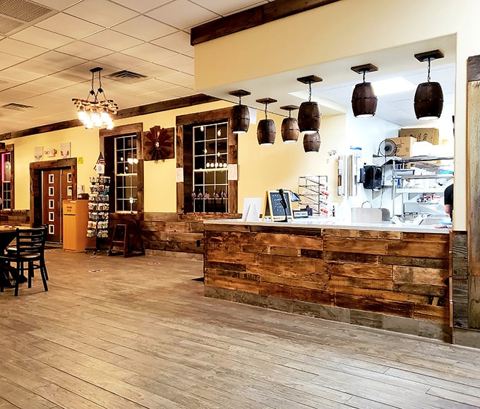Rustic charm meets functional design in this welcoming interior. Those barrel light fixtures aren't just for show—they're setting the mood for serious meat appreciation.