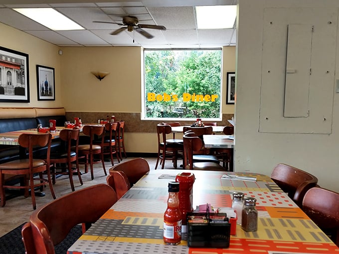Classic diner ambiance with a side of nostalgia—wooden chairs, colorful placemats, and the promise of conversations that matter more than your Instagram feed. 