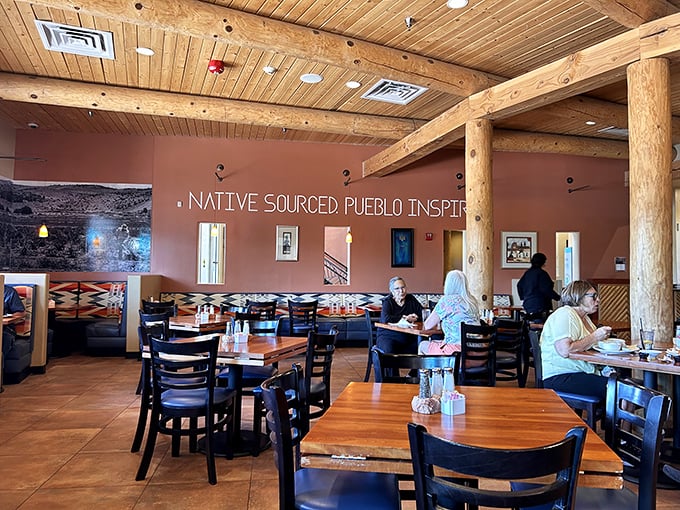 Massive wooden vigas frame a dining room where "Native Sourced Pueblo Inspired" isn't just wall decor—it's the delicious mission statement you're about to taste.