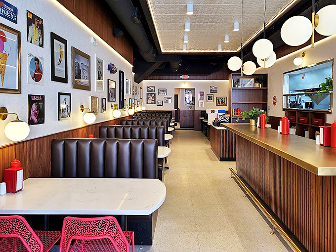 Sleek booths, globe lighting, and art-adorned walls create a modern diner vibe where comfort meets cool—the perfect backdrop for burger epiphanies.