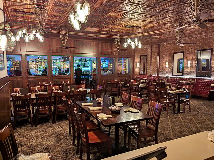 Step inside and time stands still – ornate tin ceilings, exposed brick walls, and warm lighting create the perfect stage for culinary drama.