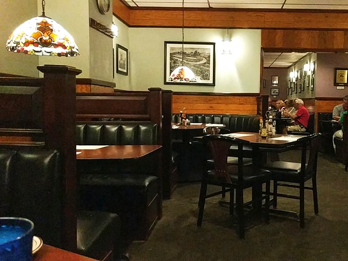 Dark wood paneling and Tiffany-style lamps create that perfect old-school steakhouse ambiance—the kind where important life decisions and excellent dinner choices happen simultaneously.