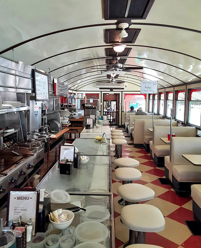 Inside the Wellsboro Diner, the checkerboard floor and curved ceiling create that perfect railroad-car coziness that's been welcoming hungry travelers for generations.