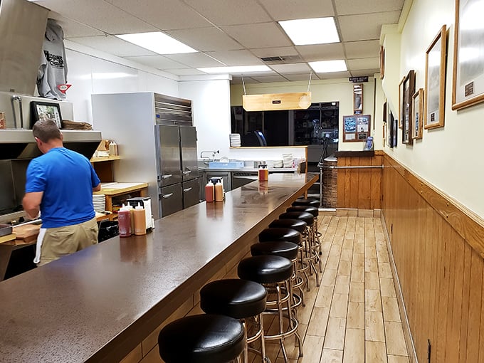 A counter that tells stories—where generations have spun on these stools, waiting for burger perfection that's worth every minute.