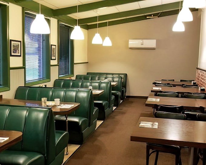 Classic green vinyl booths invite you to slide in and stay awhile. This isn't Instagram-bait décor—it's the real deal comfort of a beloved local institution.