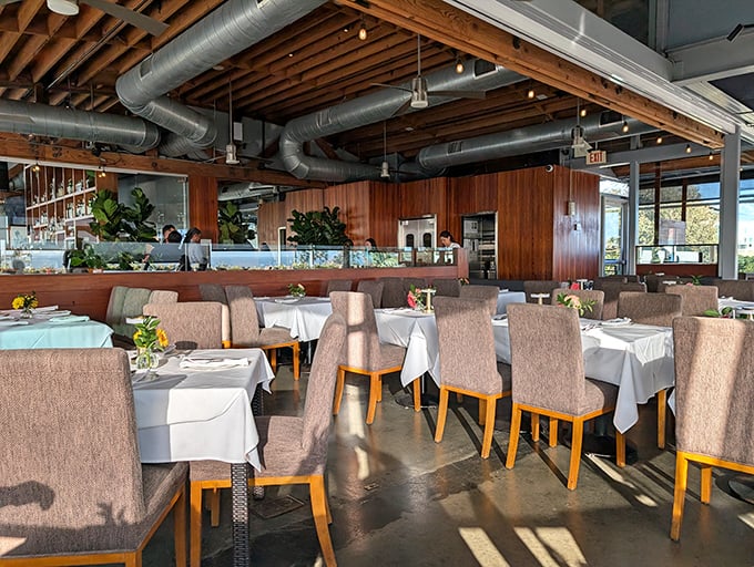 Step inside and the restaurant reveals its true character – warm wood paneling, exposed beams, and tables positioned for that million-dollar ocean view.