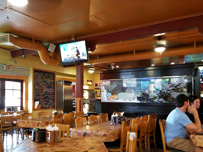 Step inside and you're transported to barbecue's promised land – wooden tables, ceiling fans, and the hypnotic dance of smoke behind glass.