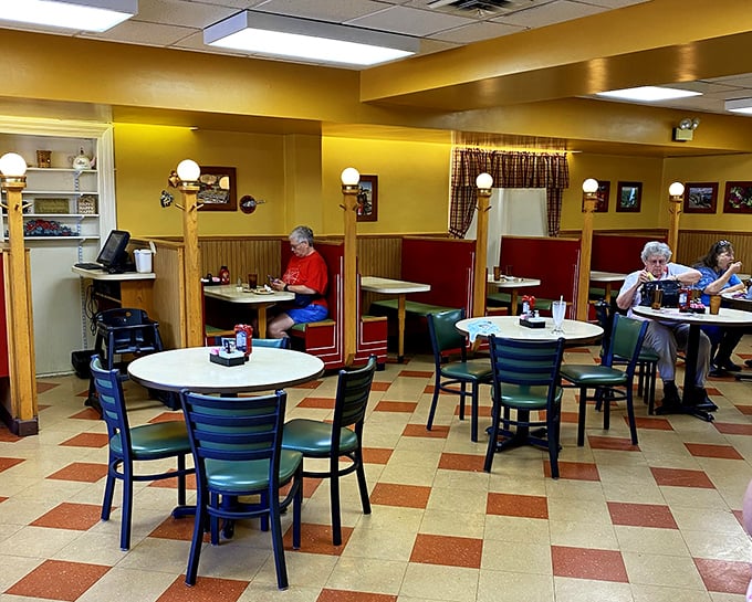 Yellow walls, red booths, and that checkerboard floor—this isn't interior design, it's a time machine to when comfort food reigned supreme.