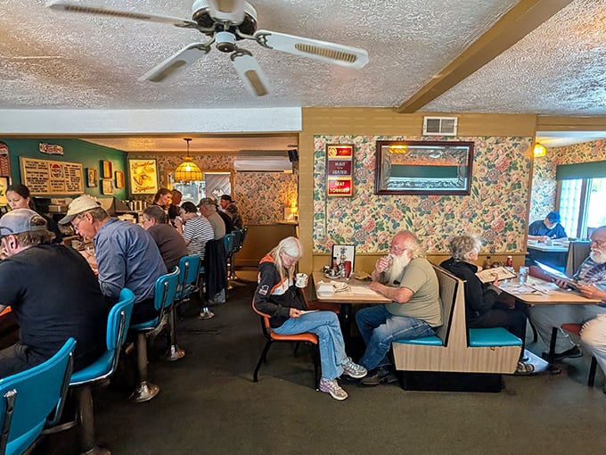 Blue chairs, floral wallpaper, and ceiling fans spinning stories overhead – Fred's interior feels like a time capsule where comfort never goes out of style.