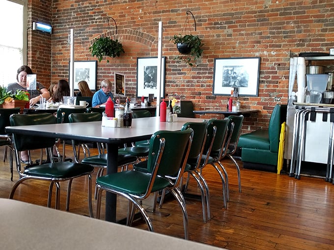 Classic green vinyl chairs and exposed brick walls create the perfect backdrop for morning conversations that flow as freely as the coffee.