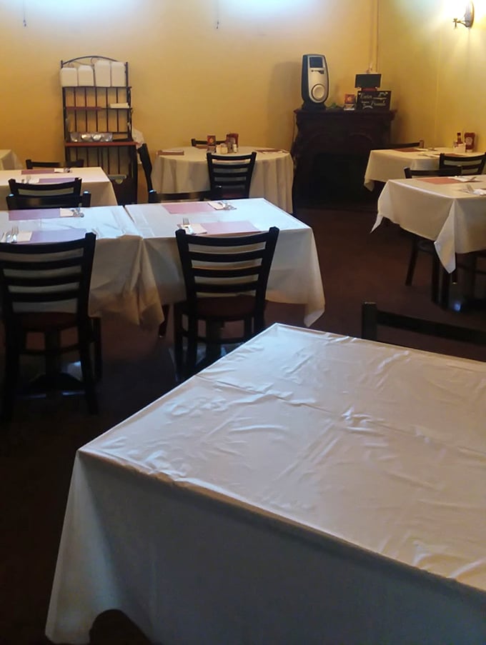 White tablecloths and simple chairs create an atmosphere of unpretentious dining elegance—no foodie theatrics, just a stage for serious eating.