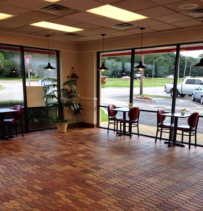 Simple tables, hexagonal floor tiles, and natural light create the perfect stage where the real stars—those magnificent donuts—can shine without distraction.