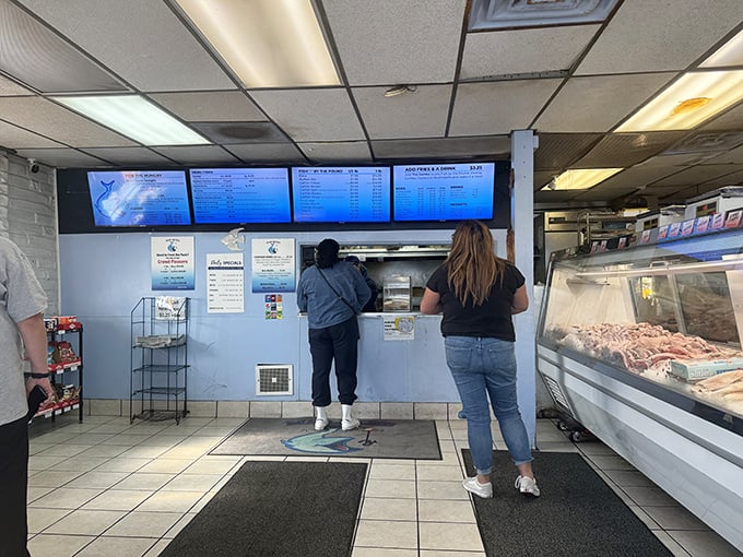 Simple counter, digital menus, and that glorious seafood case – everything you need, nothing you don't.