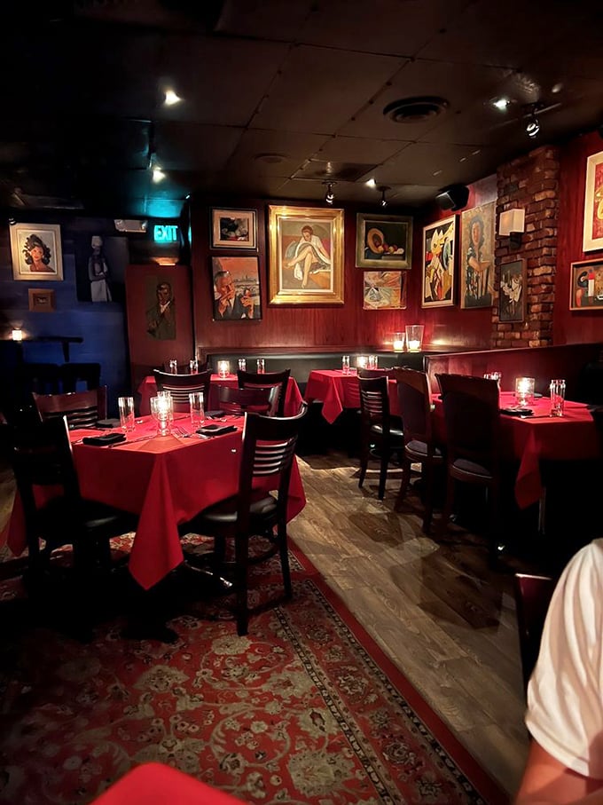 Red walls and vintage art create the perfect backdrop for conversations that actually matter—remember those?