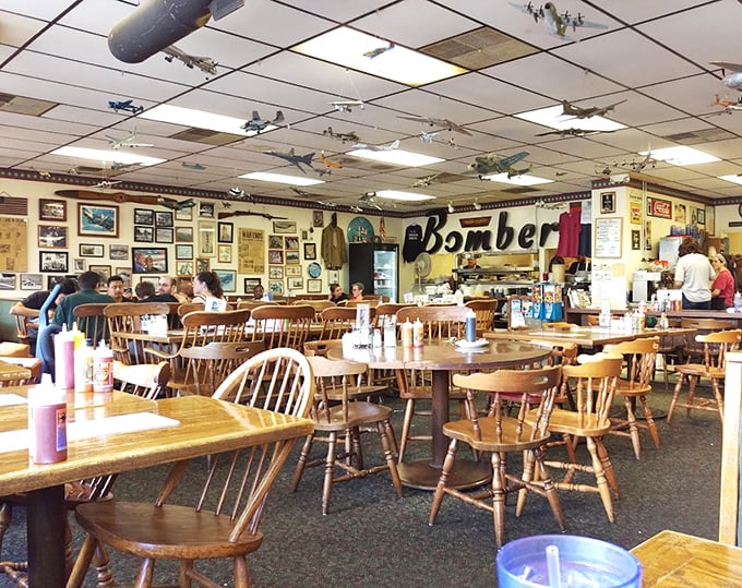 This interior shot captures the Bomber's charm – where model planes supervise your meal like tiny breakfast guardians.