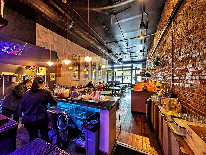 Industrial chic meets cozy comfort – exposed brick and warm lighting create the perfect backdrop for your culinary adventure.