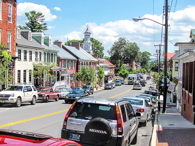 The iconic clock tower watches over Shepherdstown's main thoroughfare, where cars park along brick sidewalks that have witnessed centuries of American history.