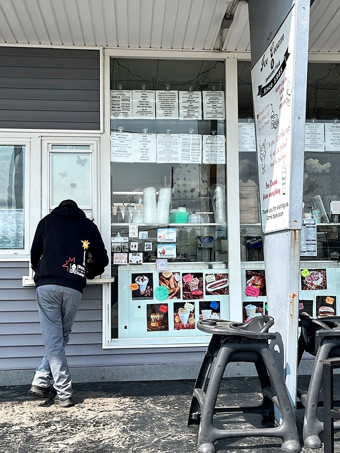 The order window—where dreams and ice cream cones are handed out with equal care. Menu boards tell stories of comfort food perfected over decades.