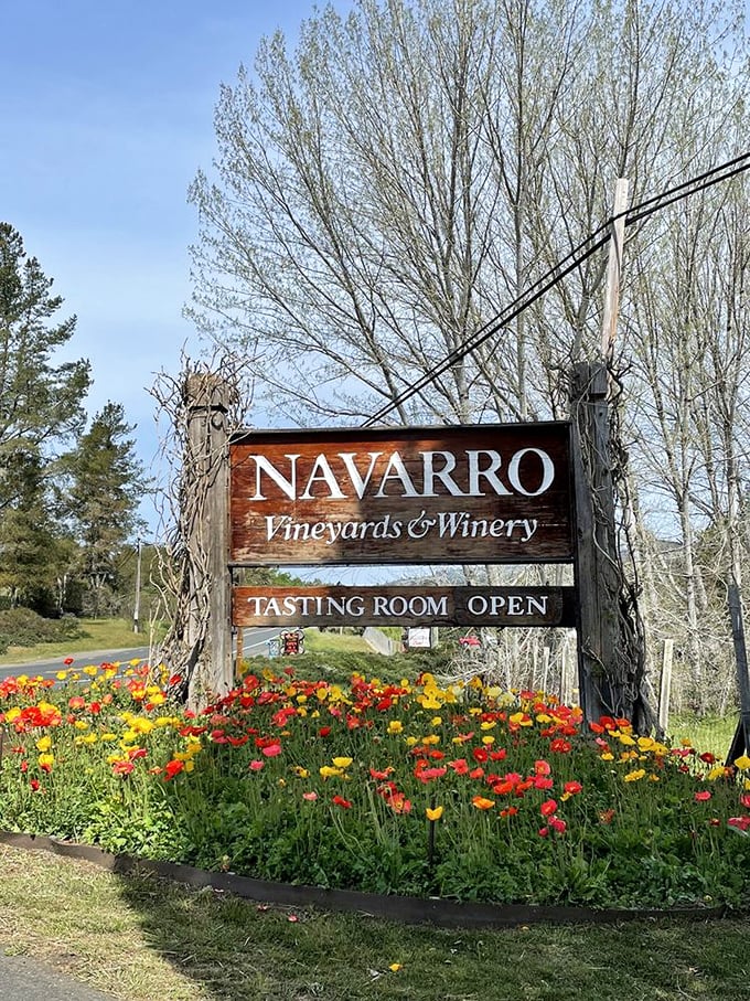 This wooden sign surrounded by wildflowers isn't just directions – it's an invitation to slow down and savor what's ahead.