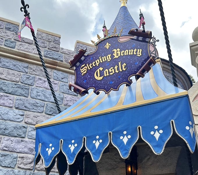 A royal blue awning marks the entrance to adventure, inviting curious souls to discover the story within these stone walls.