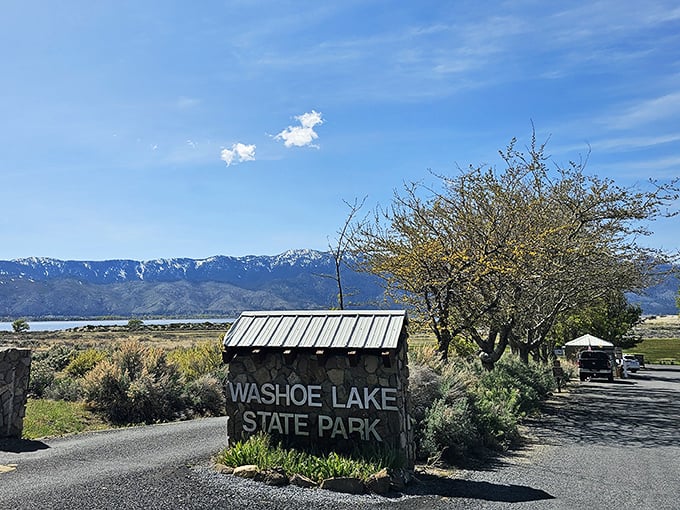 Welcome to paradise! The rustic stone entrance sign stands sentinel against a backdrop of Sierra peaks and impossibly blue Nevada skies.