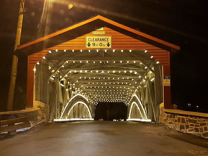 When darkness falls, string lights transform this historic crossing into something straight out of a storybook romance.