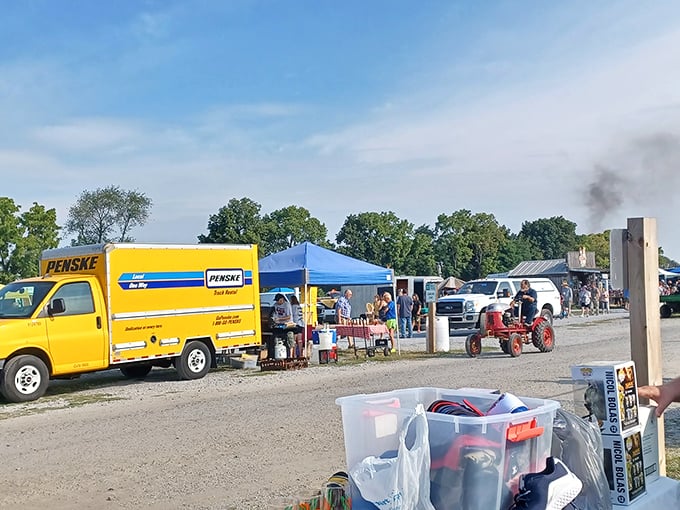 The vendor alley bustles with activity as shoppers navigate between colorful tents, each one a portal to someone else's memories and your future conversation pieces.