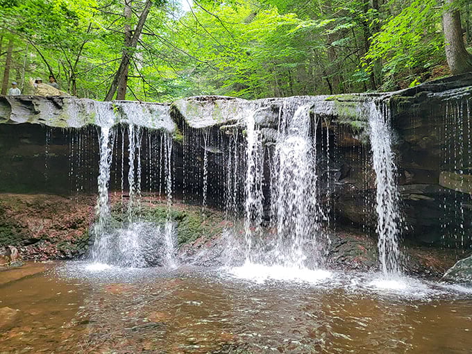 Water doesn't just fall here—it performs. This curtain-like cascade puts on a show worthy of Broadway, no tickets required.