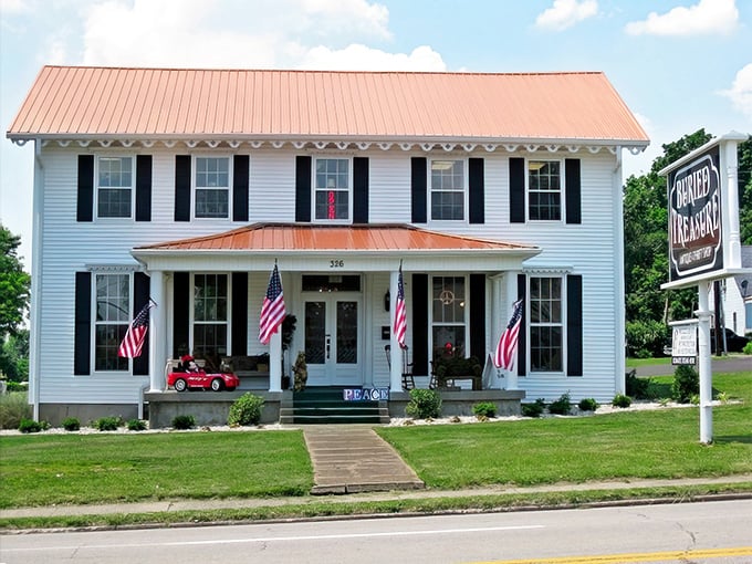 This charming white farmhouse with American flags could be hiding your next heirloom. Buried Treasure indeed!