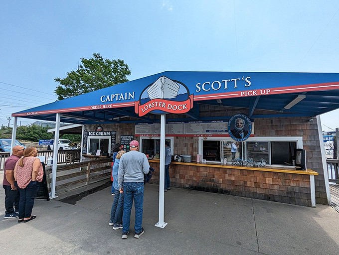 Captain Scott's blue awning beckons seafood lovers like a lighthouse guides ships—straight to lobster nirvana.