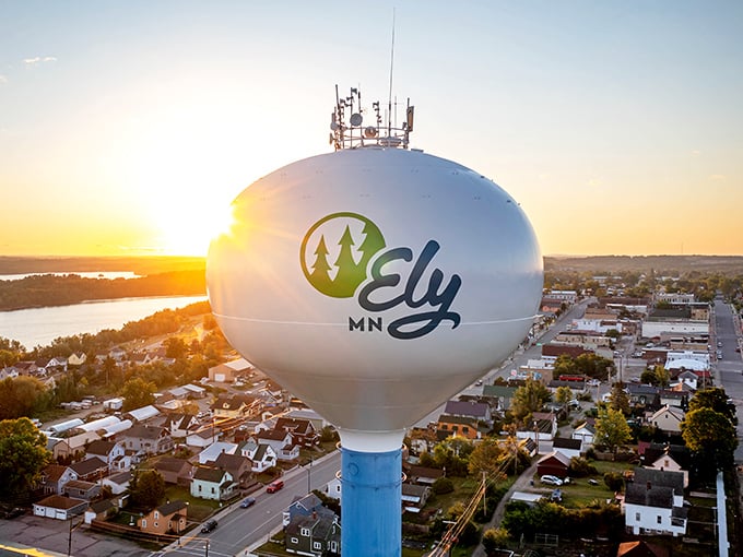 That iconic water tower stands sentinel over wilderness adventures, marking the gateway to untamed Minnesota beauty.