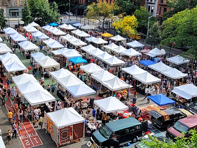 Rows of white tents stretch toward the city skyline, creating an organized maze of vintage dreams and antique possibilities.
